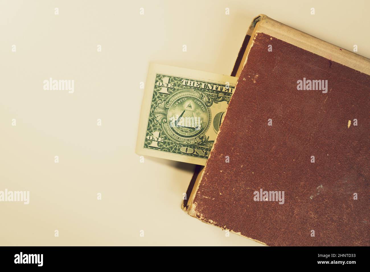 Money in a book. dollar bill used as a bookmark in the book on a white ...