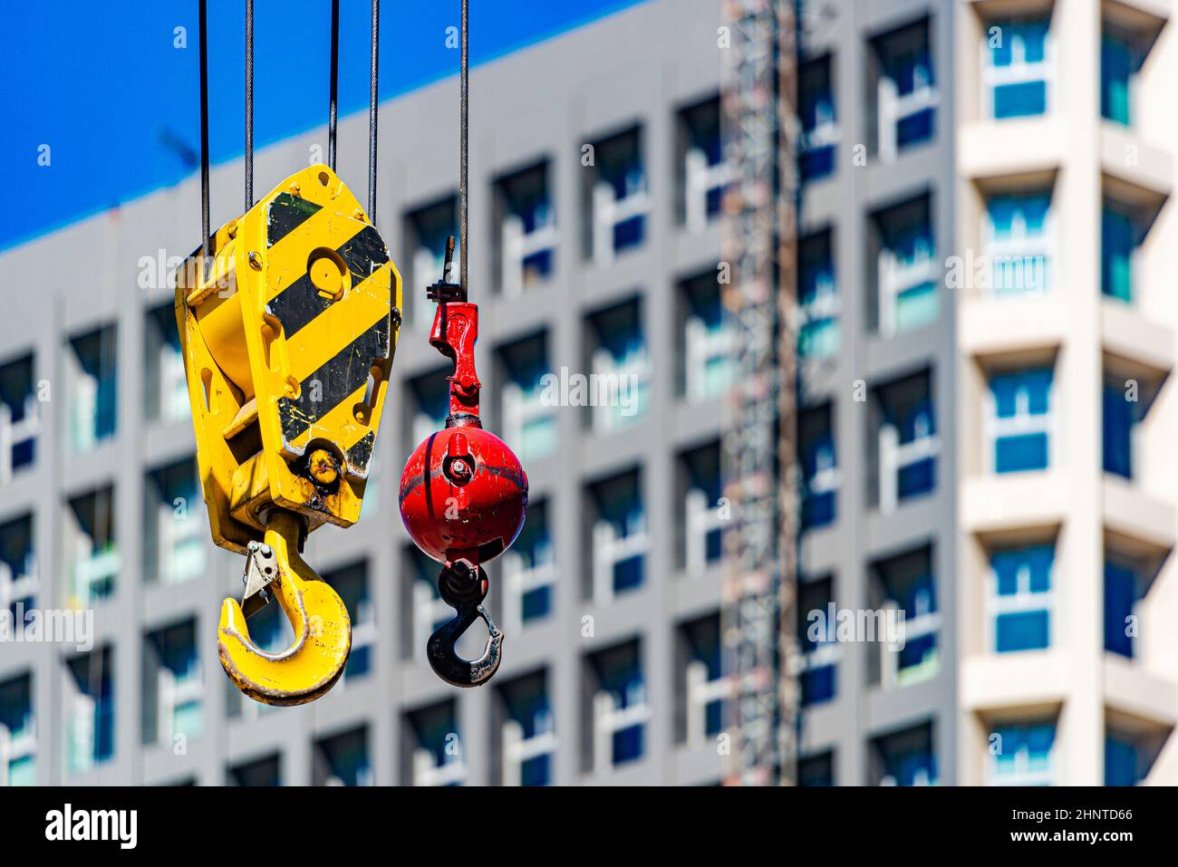 Hooks of crane on construction site Stock Photo - Alamy
