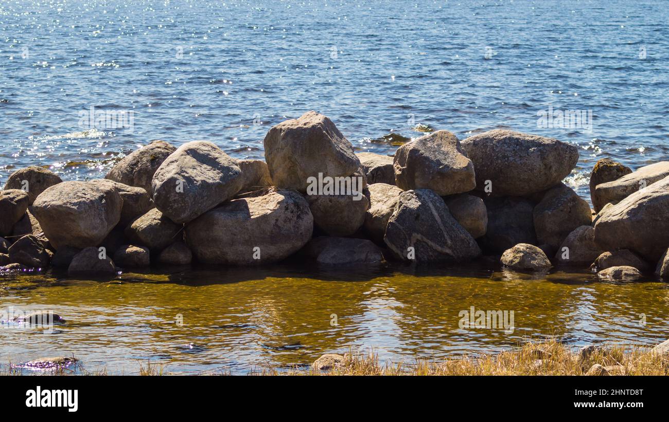 Dam from stones. dyke made from natural materials. pile of rocks in the ...