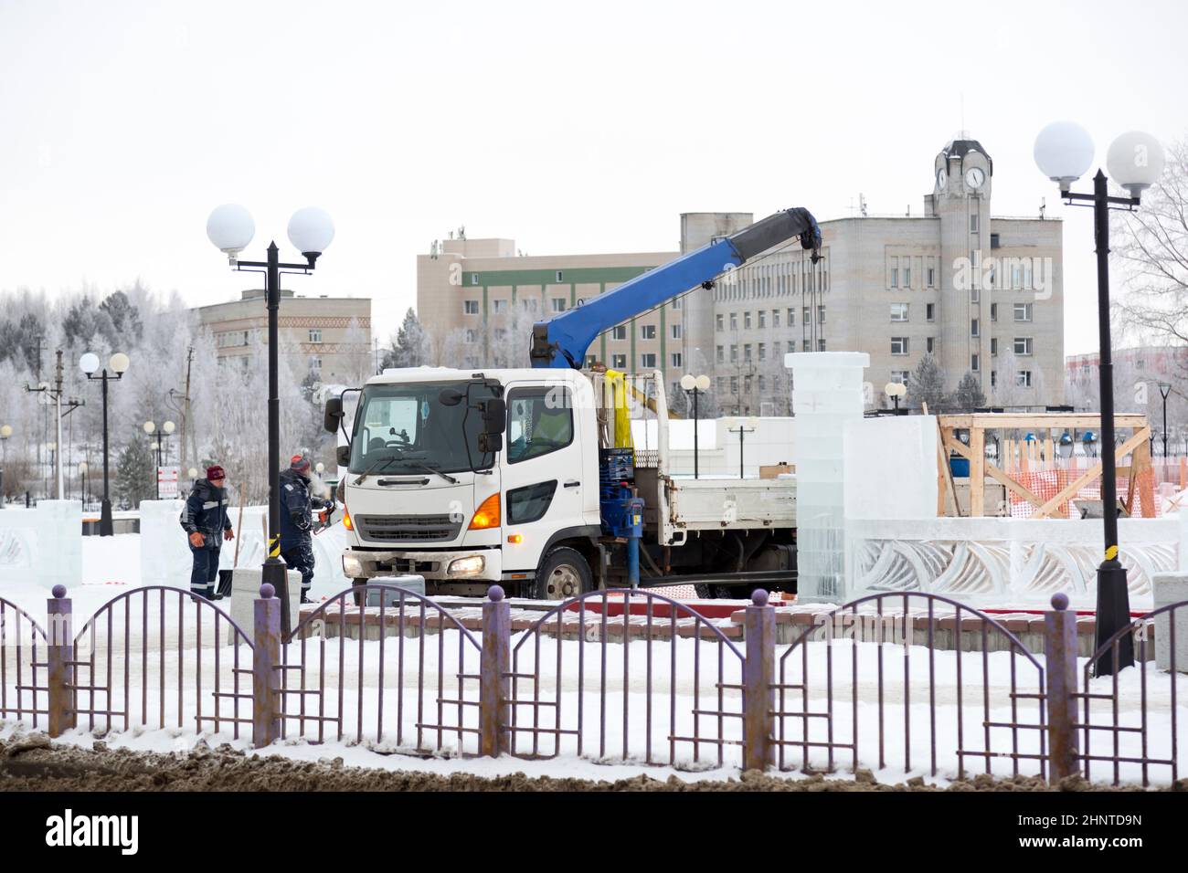 Installers at the truck crane with a chainsaw at the installation of ...