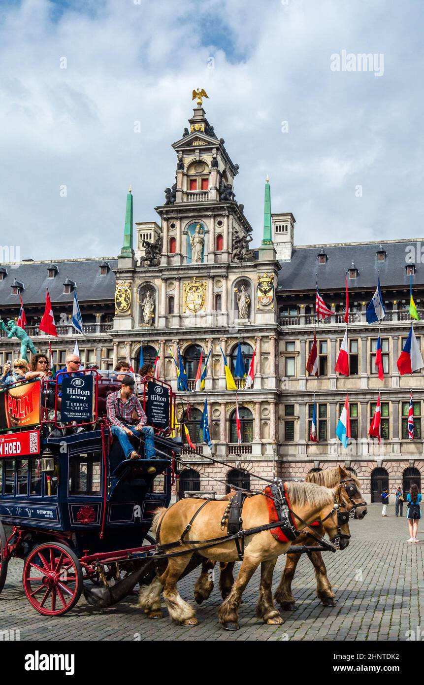 ANTWERP, BELGIUM - AUGUST 22, 2013: Tourists in a horse-drawn carriage ...