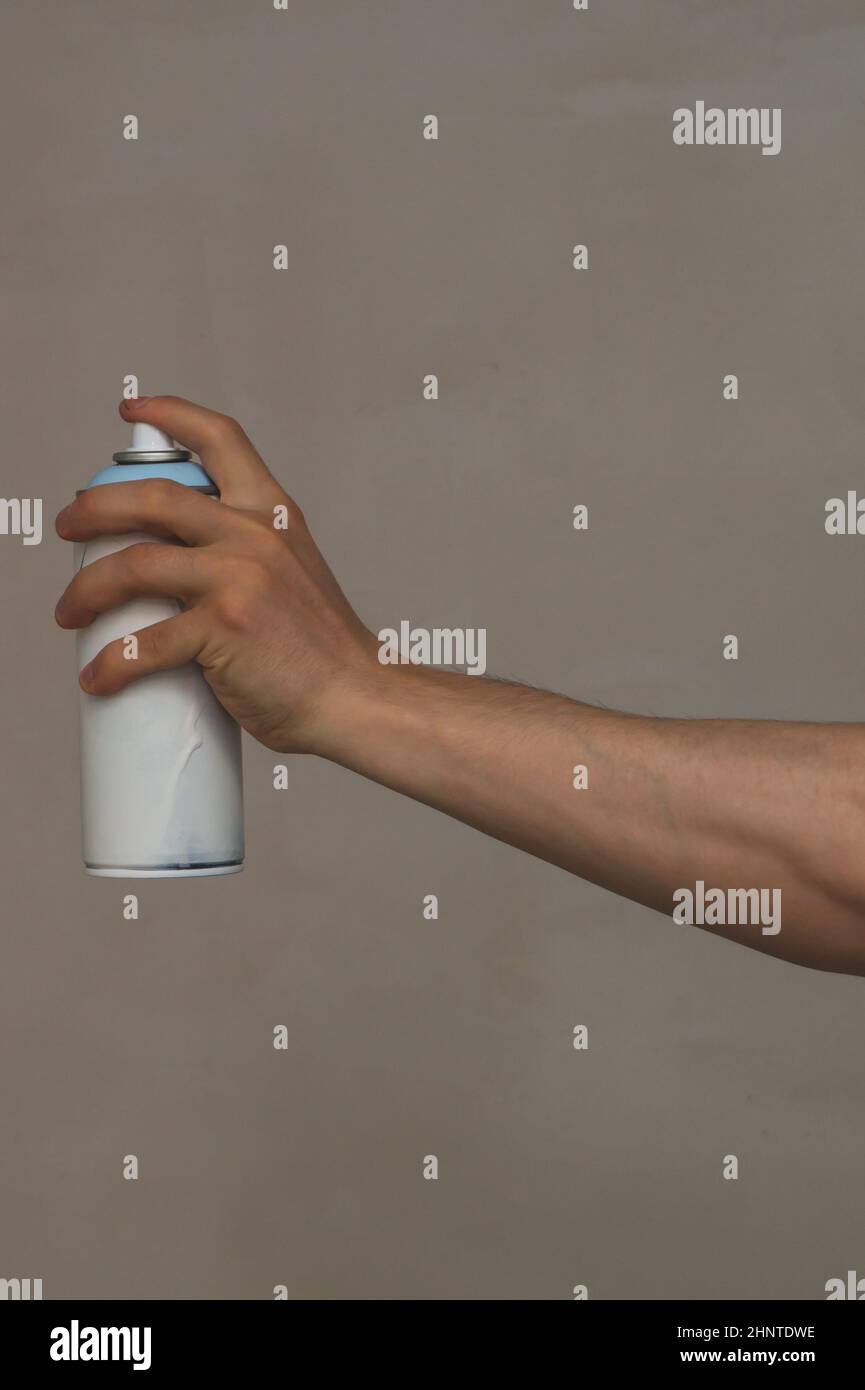 Spray can in hand. painting process Stock Photo - Alamy