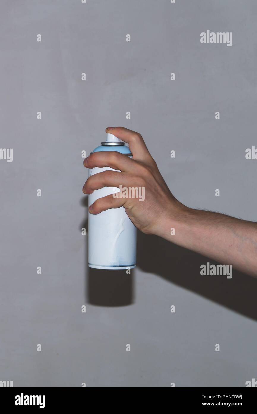 Spray can in hand. painting process Stock Photo - Alamy