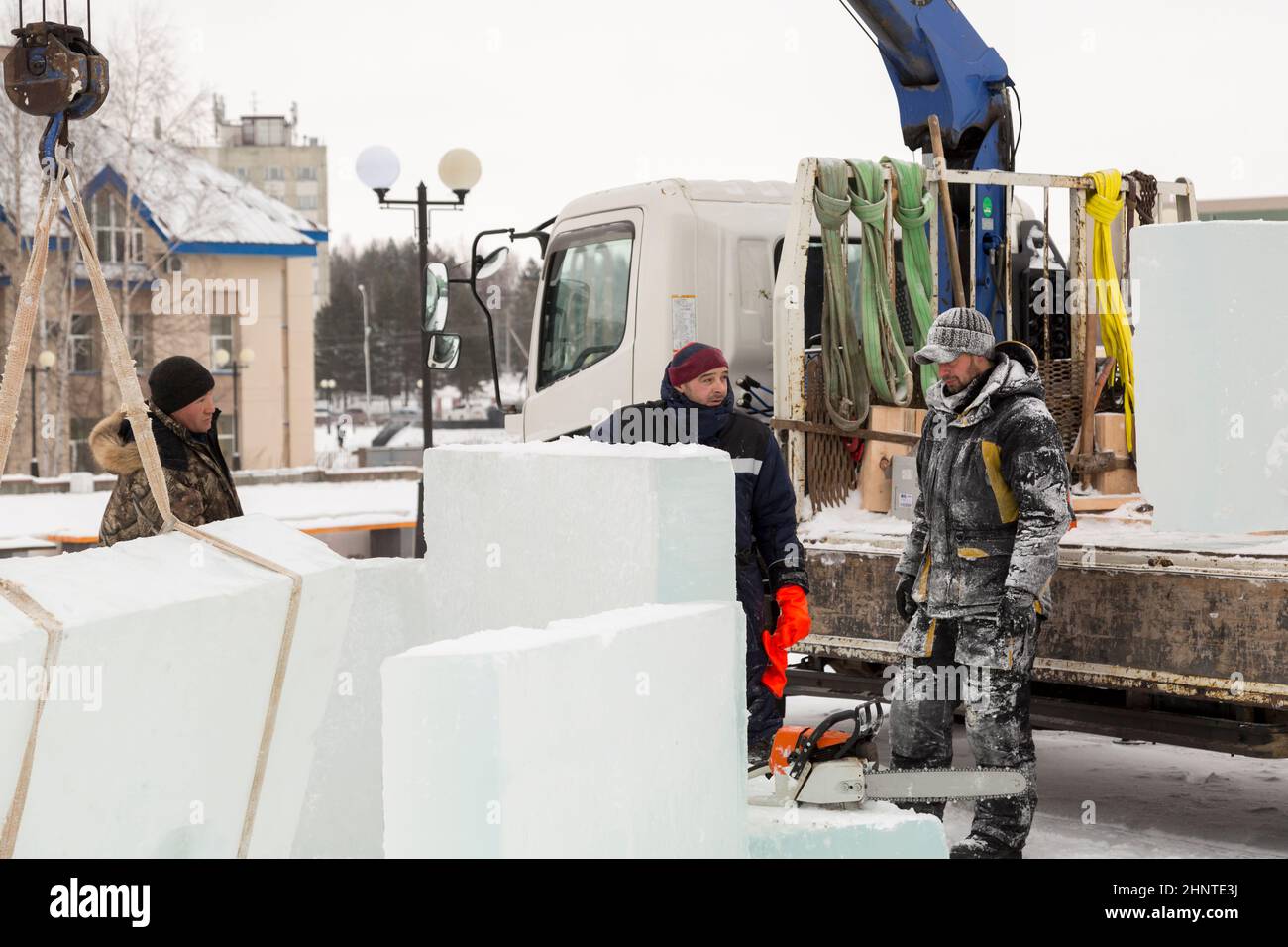 Installers at the construction site of the ice camp discuss a plan for ...