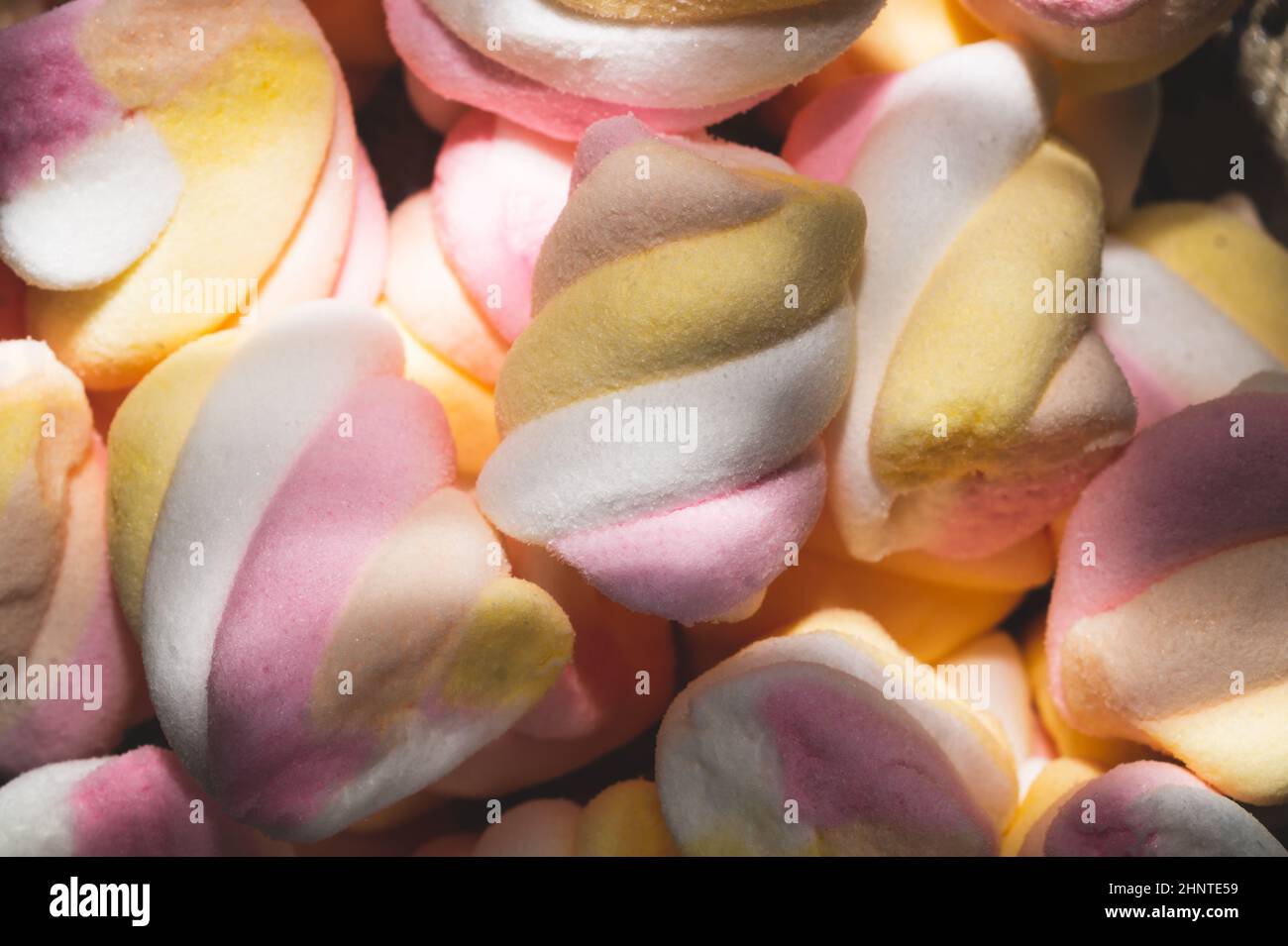 Twisted marshmallow close up. handful of chewy candy Stock Photo - Alamy