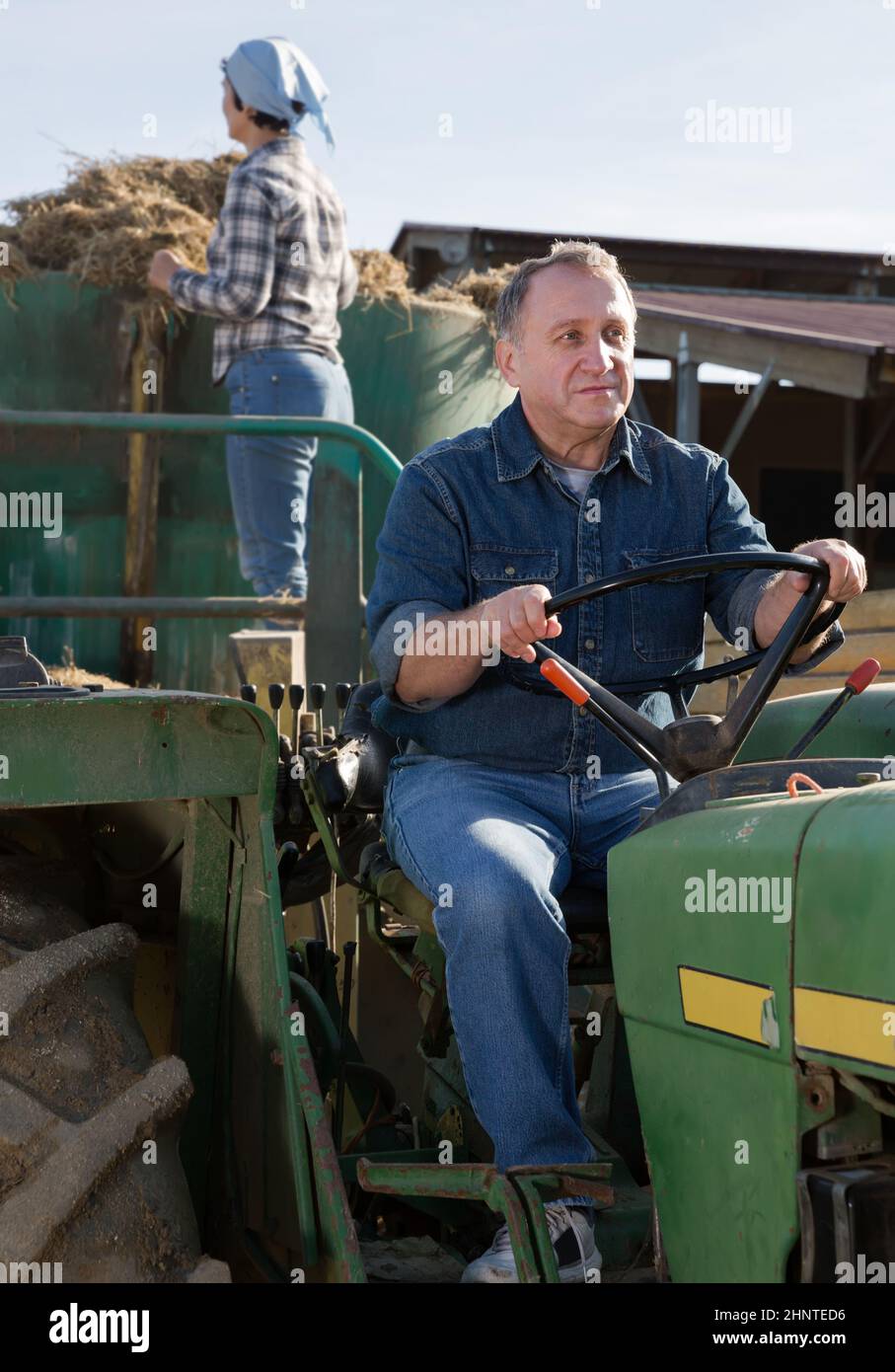 Elderly farmer driving tractor hi-res stock photography and images - Alamy