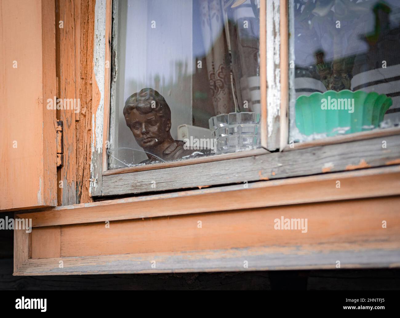 the bust of a poet on the windowsill inside the wooden window Stock ...