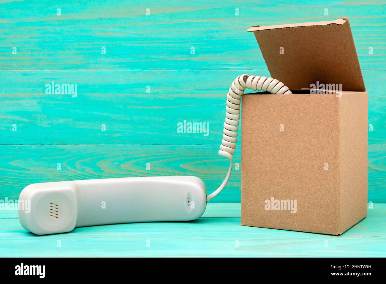 Surprise call inside a cardboard box. Old telephone receiver in brown ...
