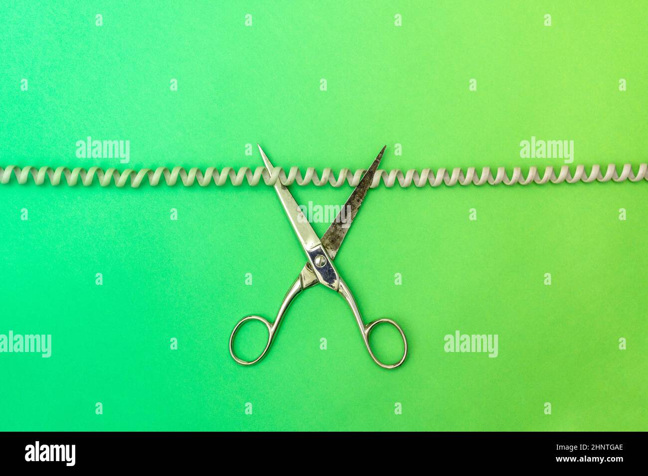 Phone cord being cut by scissors. Concept disconnected communication ...