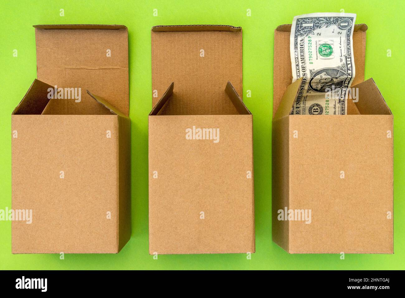 Three open boxes and dollar bulging out of one of them. Financial ...