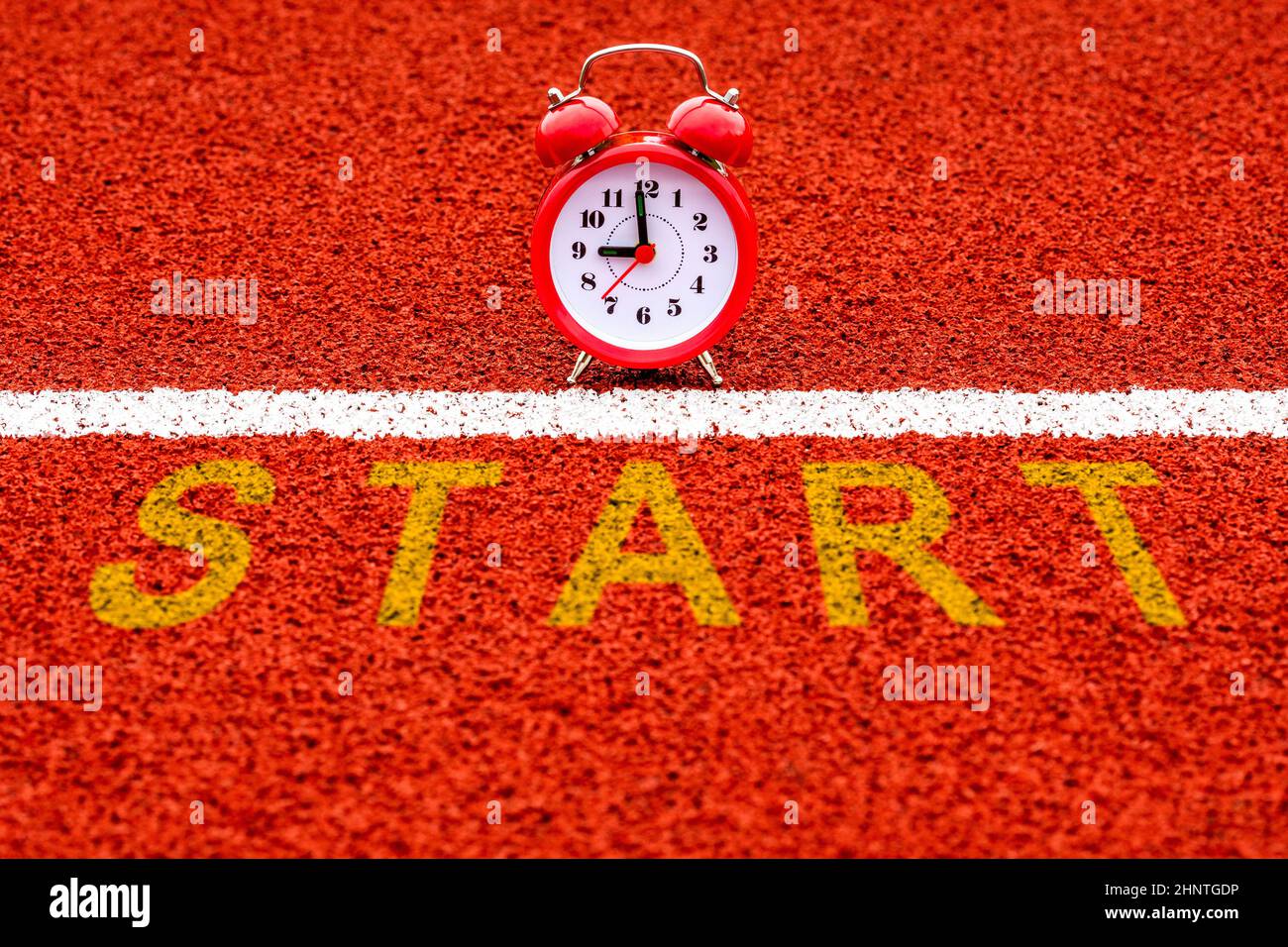 Alarm clock with the word START on the road in the morning. Start ...