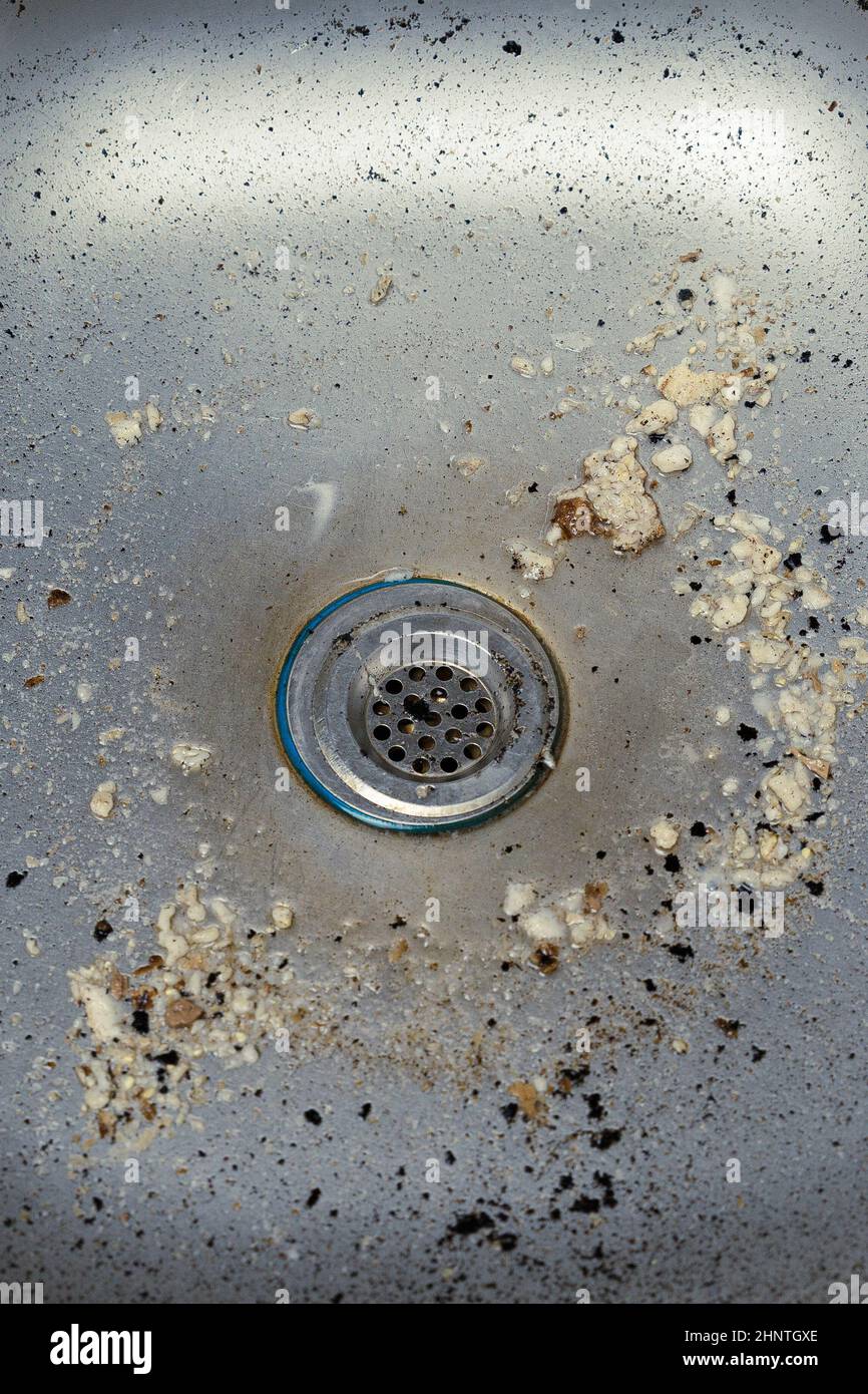 Cleaning service concept. Dirty kitchen sink with food leftovers Stock ...