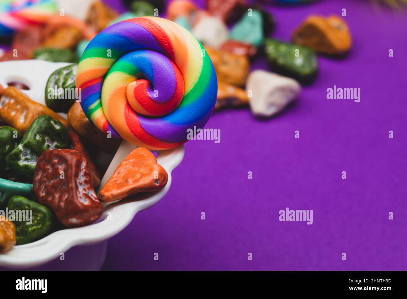 Lollipops and candy pebbles. sweets in the form of colored stones ...