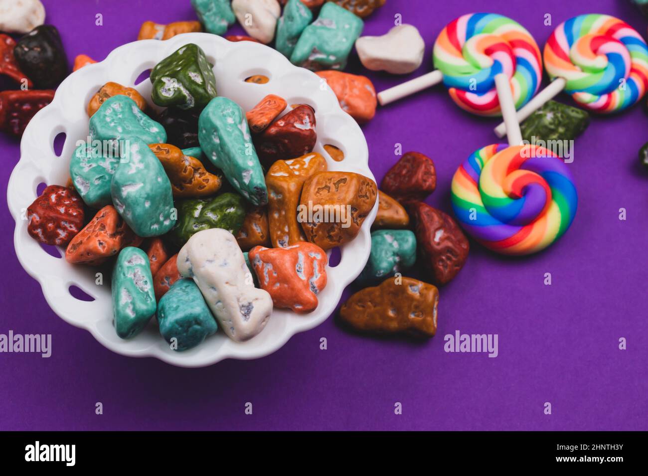 Lollipops and candy pebbles. sweets in the form of colored stones ...