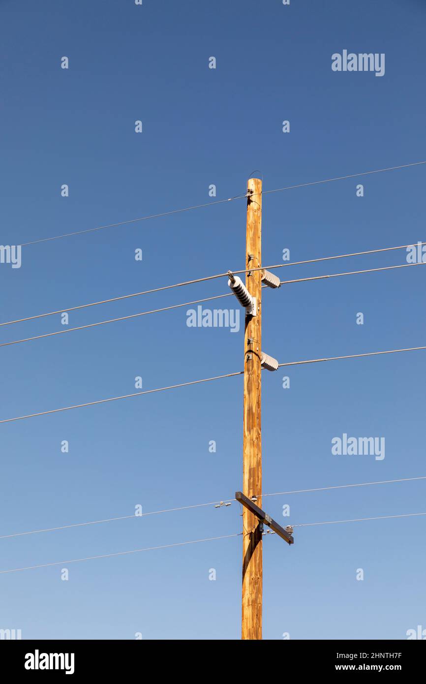 wooden electric pylon under clear blue sky Stock Photo - Alamy