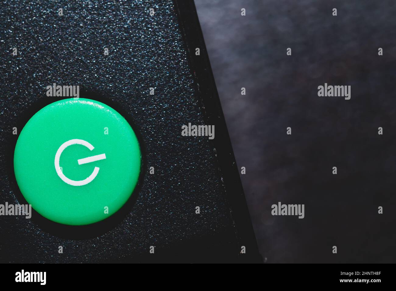 Green power button on the remote control close up Stock Photo - Alamy
