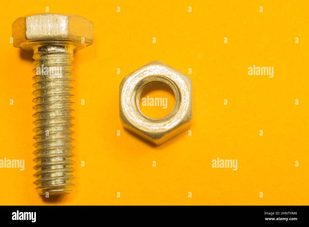 Steel screw on a yellow background. working tools Stock Photo - Alamy