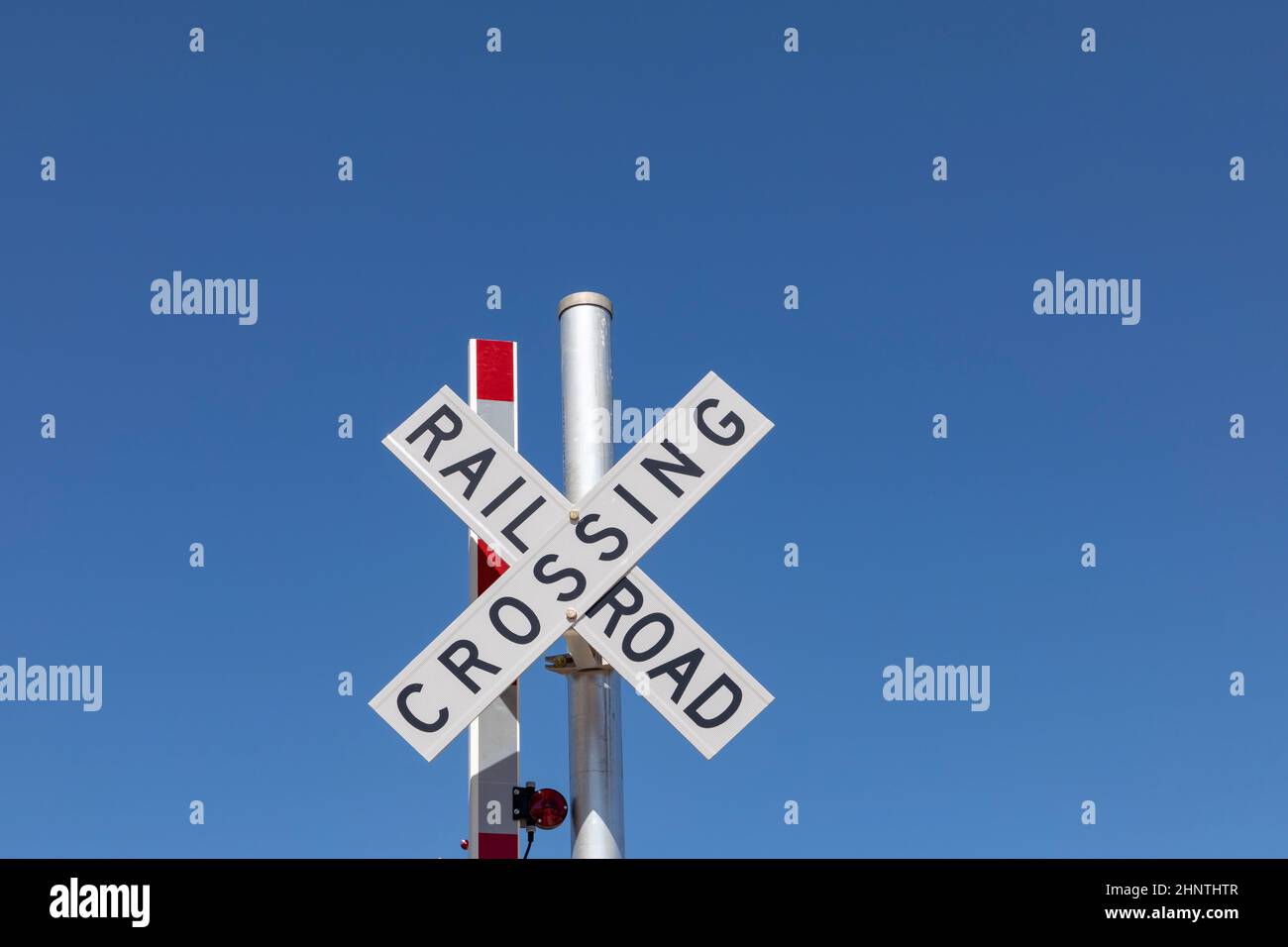 railroad crossing sign under clear blue sky Stock Photo - Alamy