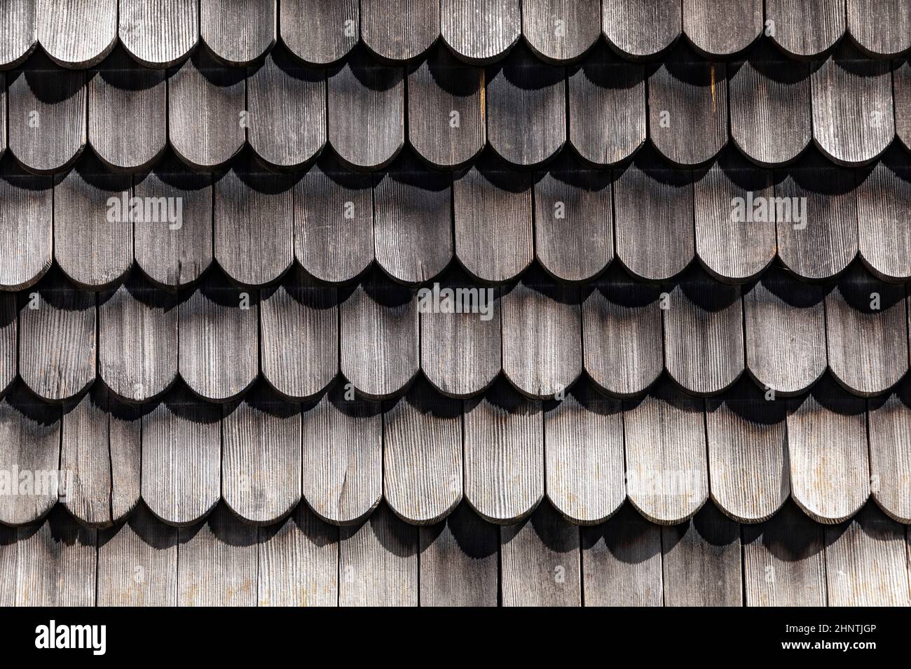 wooden weathered tiles at a house wall of a historic german house ...