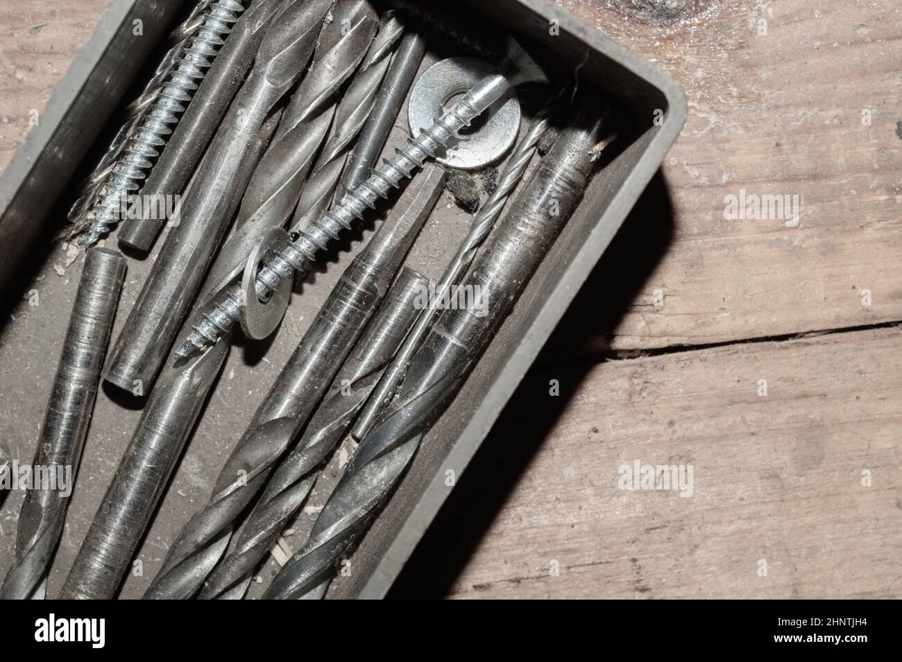 Different drills in a box. pile of drill bits in a case. working tools ...