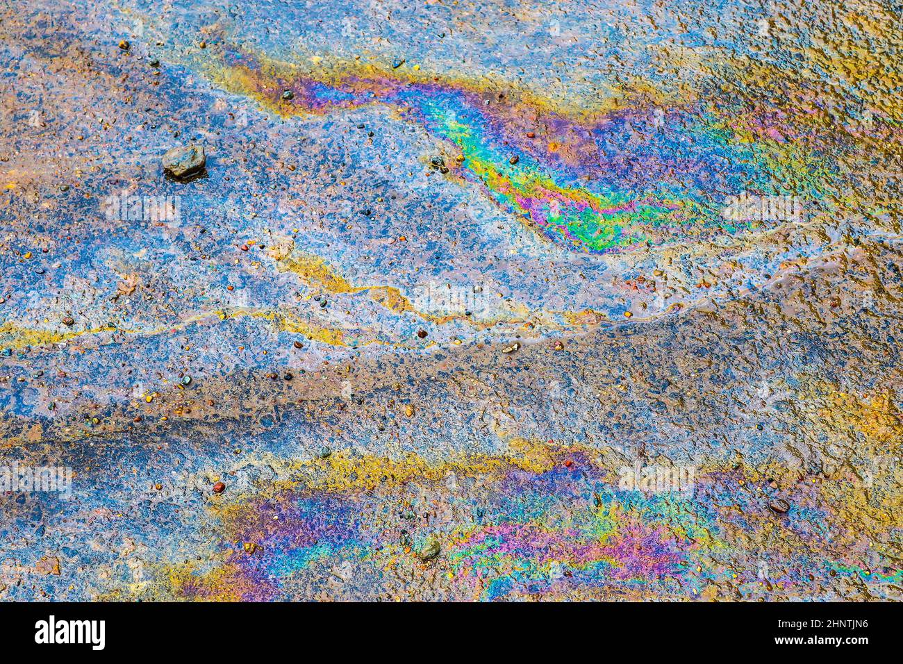 Colorful fuel and oil on an asphalt texture heavy showing enviromental ...