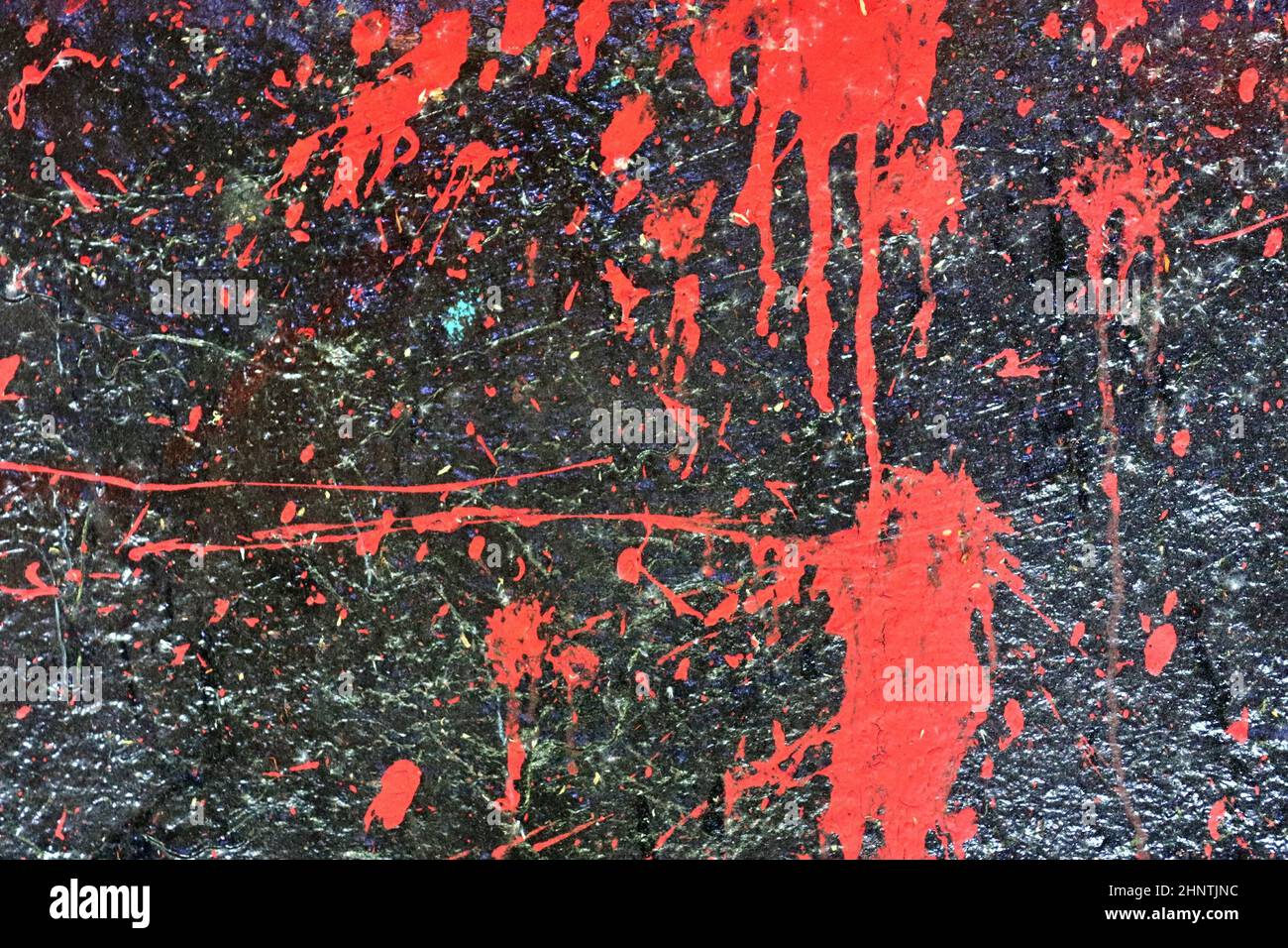 Colorful graffiti paint splashes on the wall and ground at a lost place ...