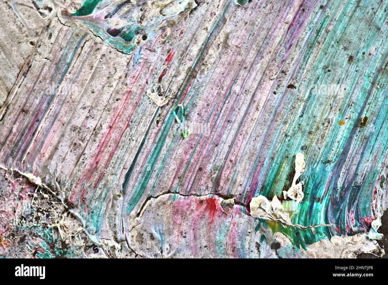 Colorful graffiti paint splashes on the wall and ground at a lost place ...
