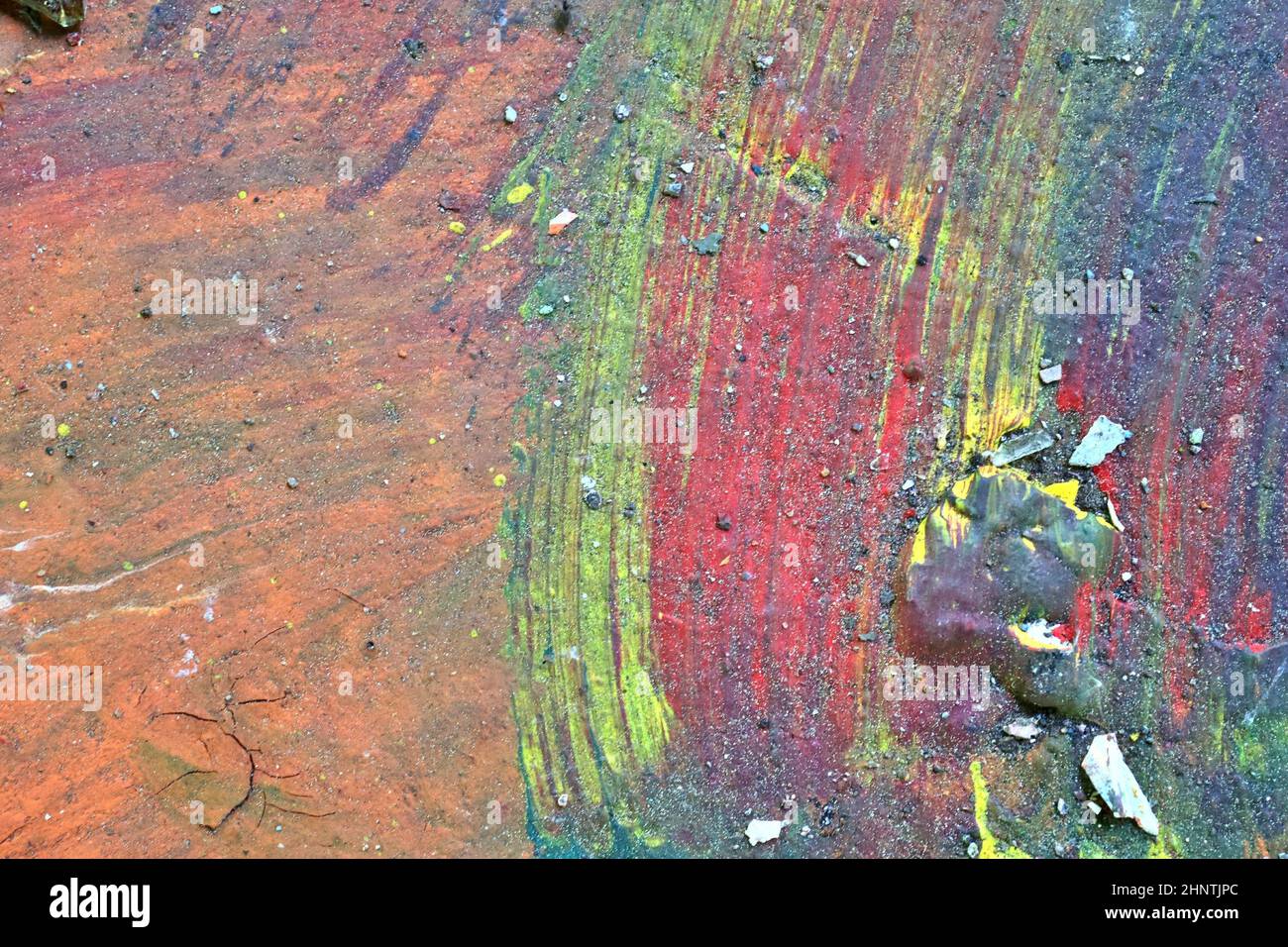 Colorful graffiti paint splashes on the wall and ground at a lost place ...