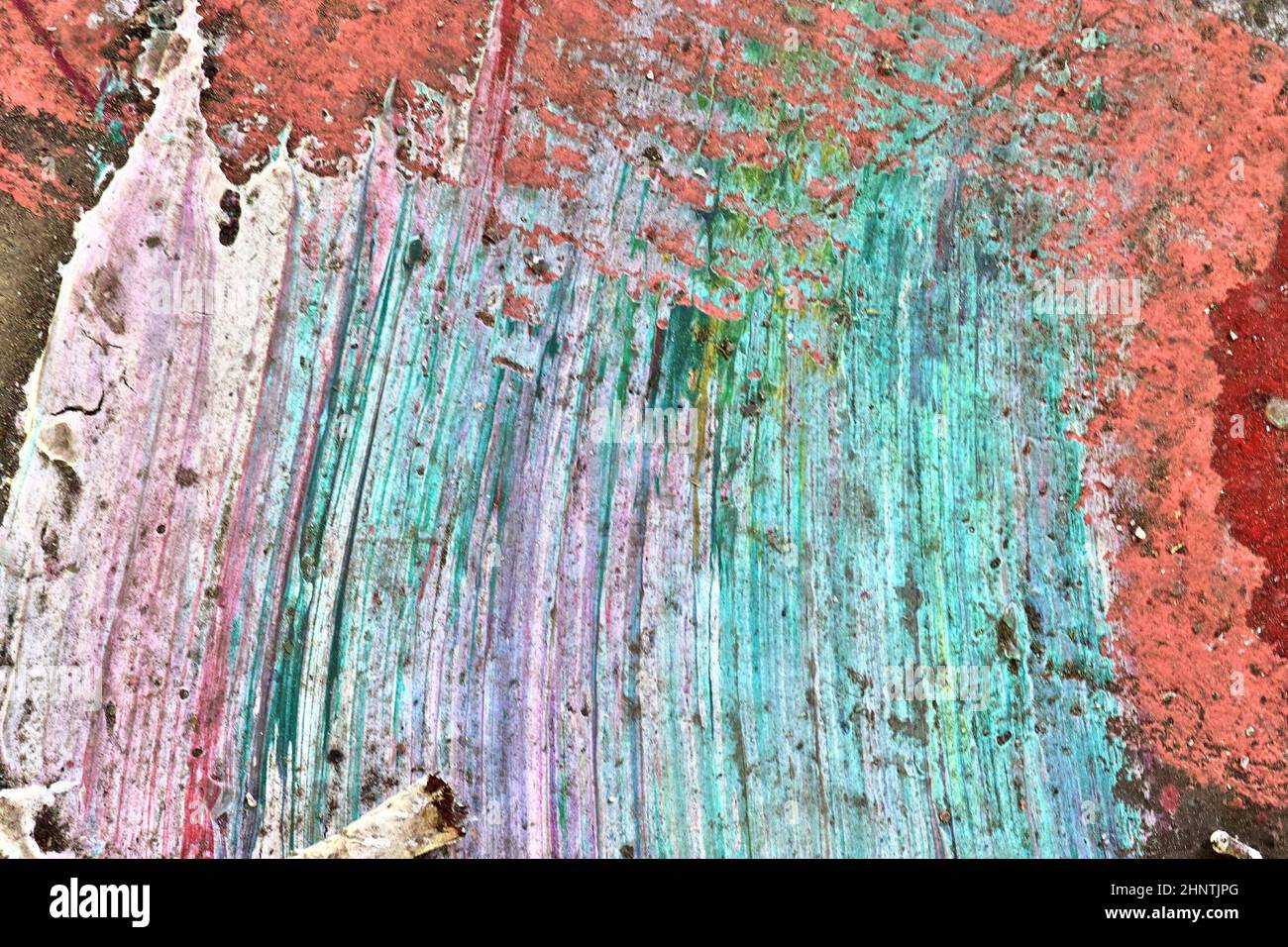 Colorful graffiti paint splashes on the wall and ground at a lost place ...