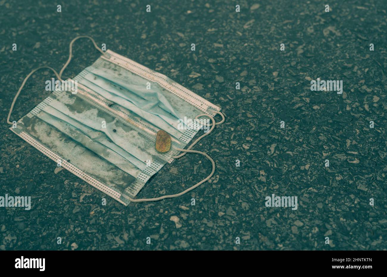 Used medical face mask discard on floor. Medical waste disposal with ...