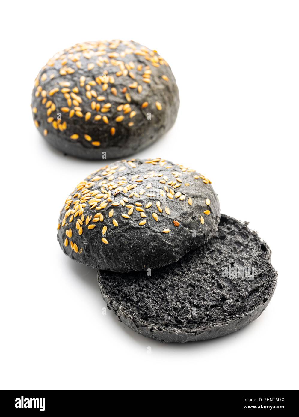 Black bun. Dark pastry with sesame seeds isolated on white background ...