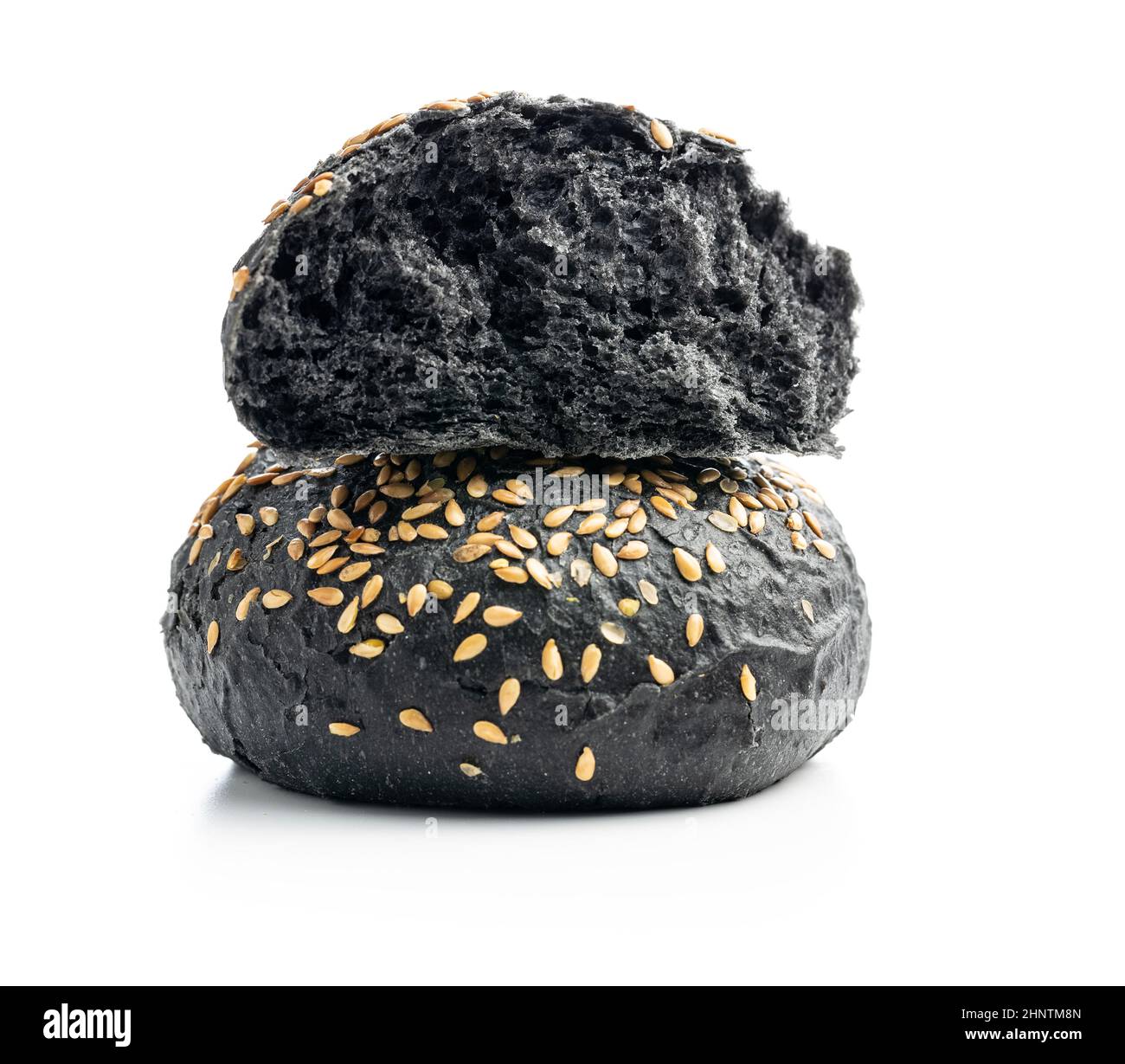 Black bun. Dark pastry with sesame seeds isolated on white background ...