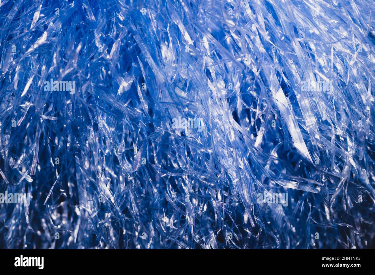 Abstract blue texture with wavy plastic stripes. blue tinsel macro ...