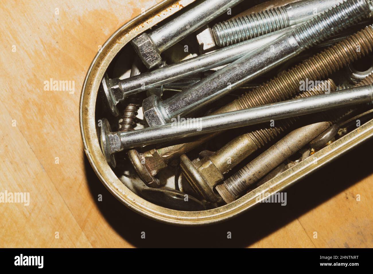 Old screws in a box. a lot of various screws. pile of fasteners in the ...