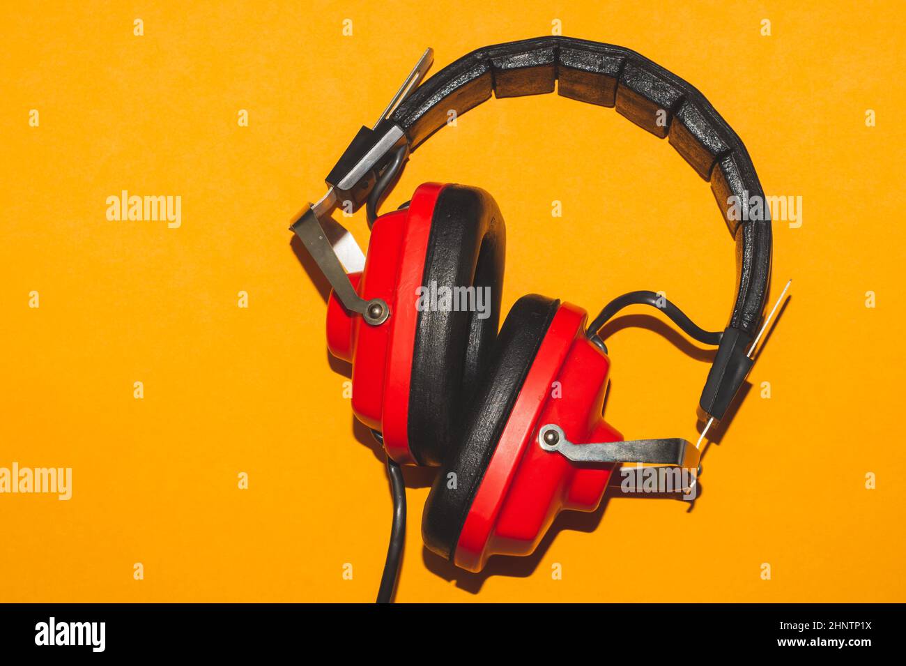 Vintage red headphones on yellow background. retro earphones Stock ...