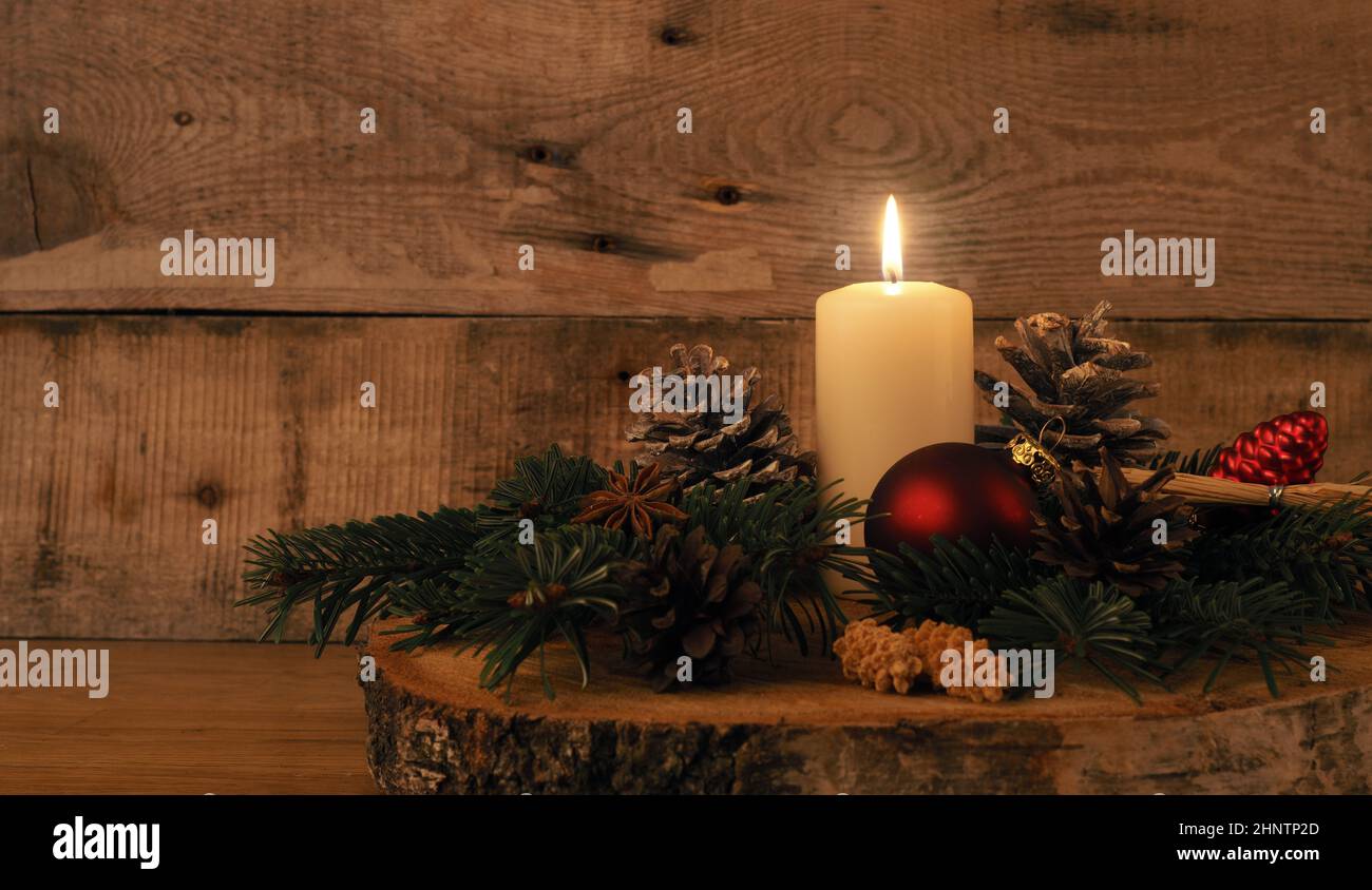 First Advent, one candle burning on a rustic wooden table with ...