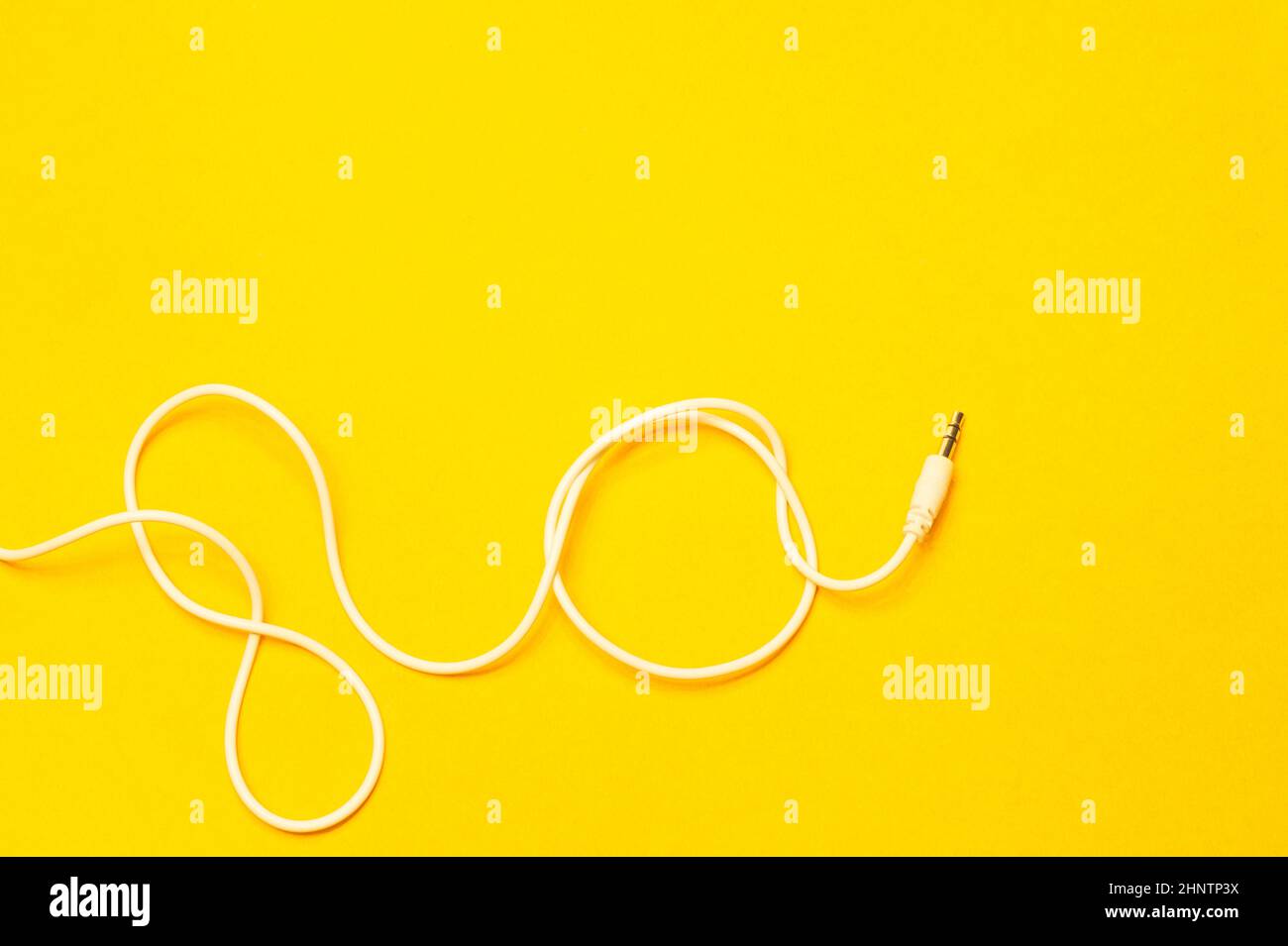 Audio jack with white cable isolated on yellow background Stock Photo ...