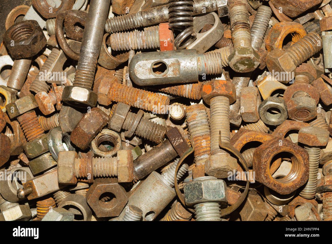 Rusty bolts and nuts of different sizes. scrap metal. industrial ...