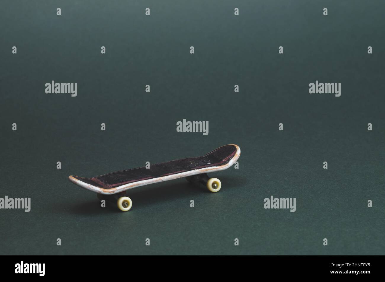 Small skateboard on color background. tiny skate for fingers ...