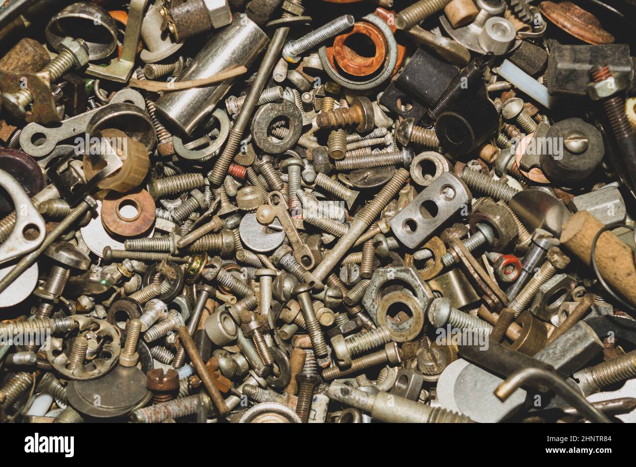 Pile of fasteners and screws close up. scrap metal. different metal ...