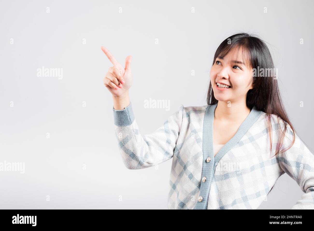 Smiling happy woman pointing finger out space, Portrait Asian beautiful ...