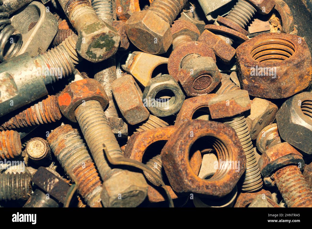 Rusty bolts and nuts of different sizes. scrap metal. industrial ...
