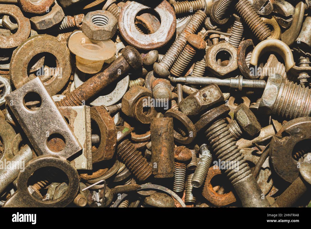 Pile of fasteners and screws close up. scrap metal. different metal ...