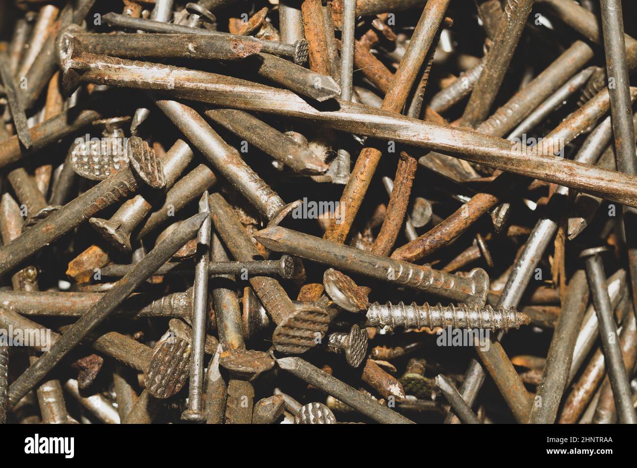 Pile of fasteners and screws close up. scrap metal. different metal ...