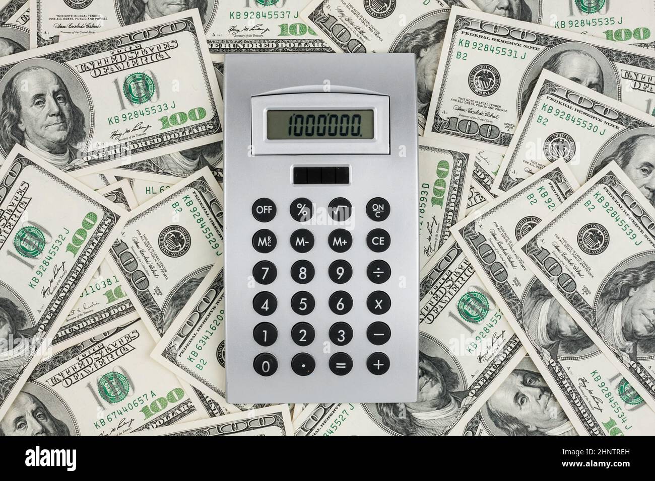 Background of $ 100 bills and a calculator can be used as background ...