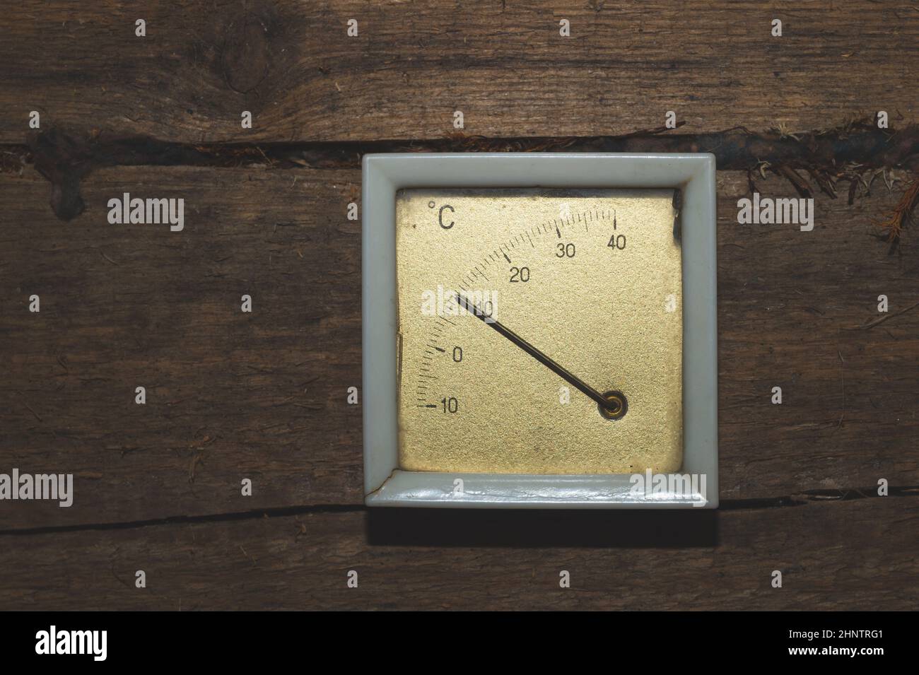 Vintage thermometer hanging on a wooden wall. celsius scale with ...