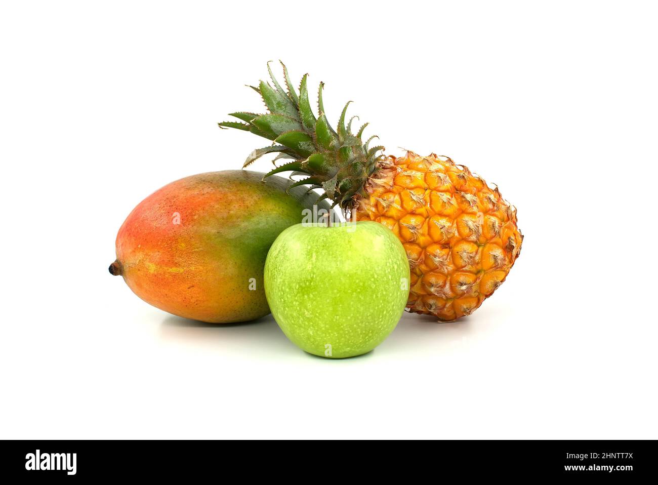 Whole mango, pineapple fruit and apple isolated on a white background ...