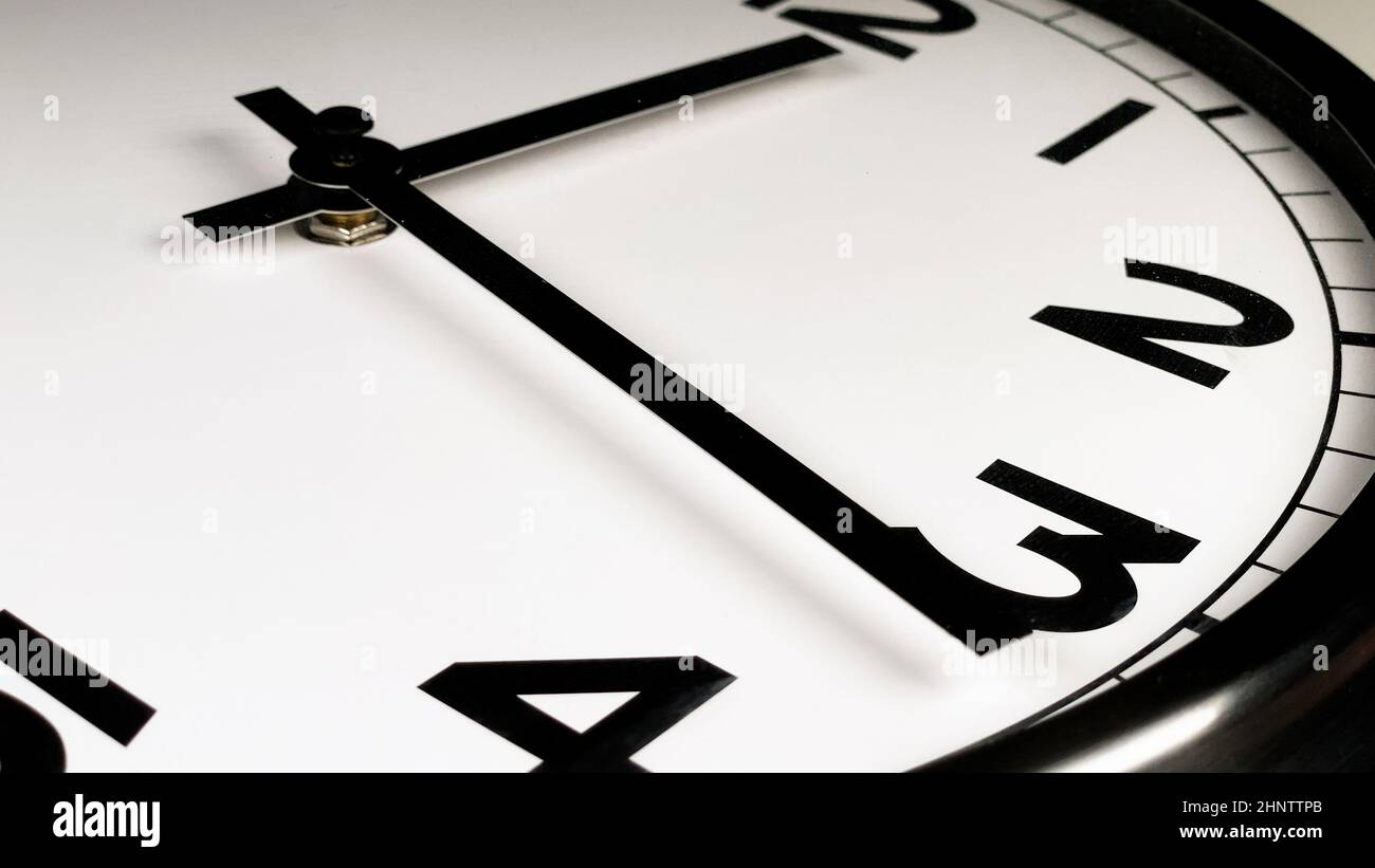 Close-up time lapse of a quartz watch with black hands and white dial ...