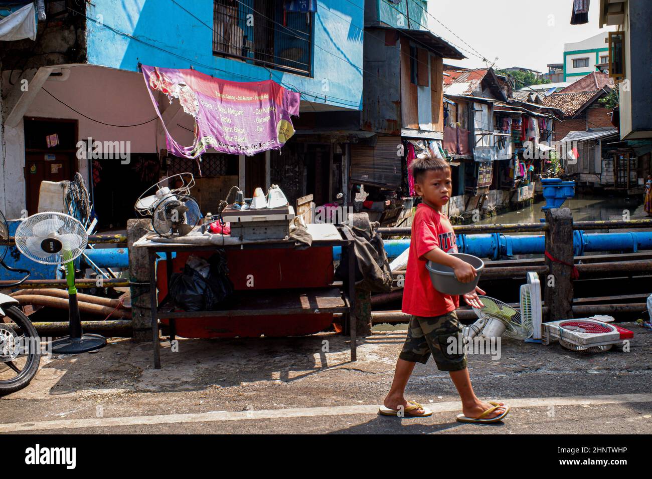 A young child walks on a bridge near the slum area in Tanah Abang ...
