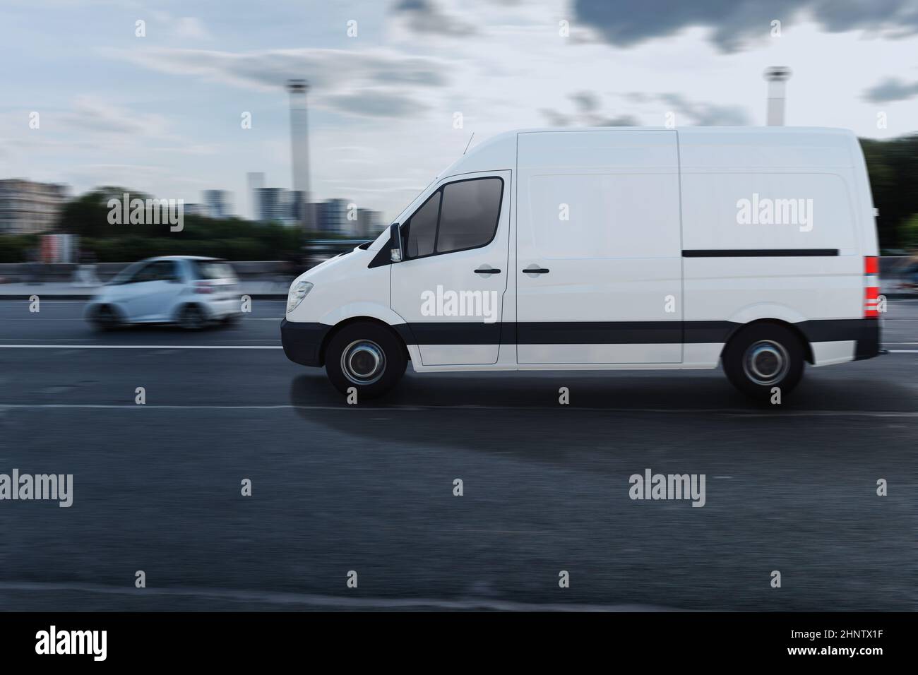 White moving van on a city road Stock Photo - Alamy